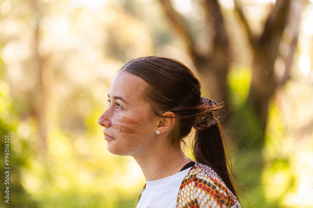 Side profile of teen aboriginal girl looking up wearing traditional ...