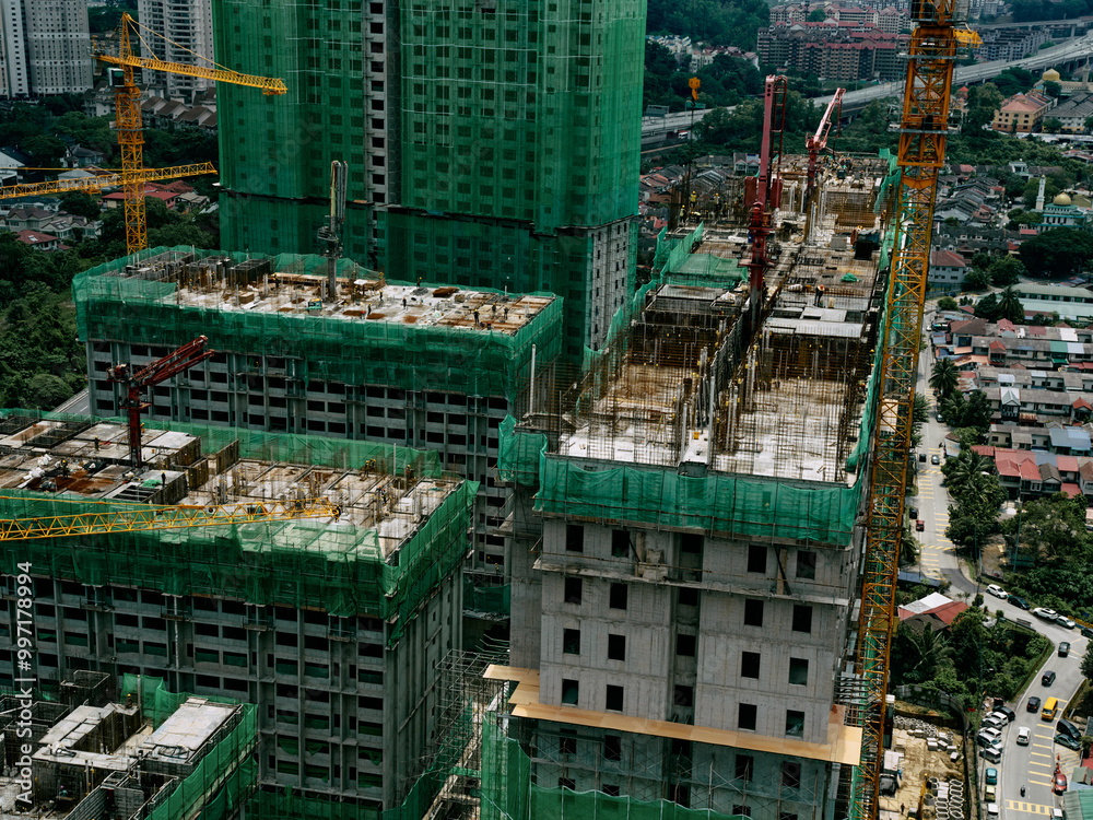 Construction site of a high rise building with cranes and scaffolding ...
