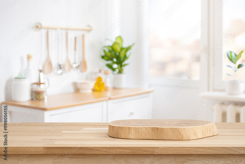 Podium or cutting board on wooden table on defocused rustic kitchen ...