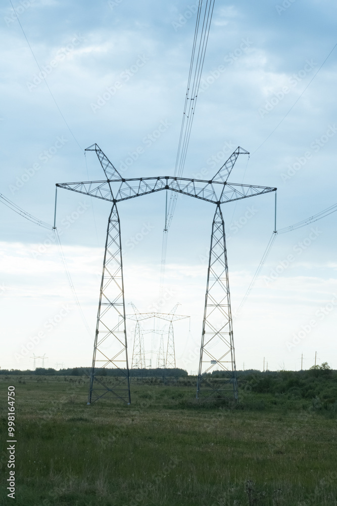 Foto de Stock High voltage pylons against the blue sky with white ...