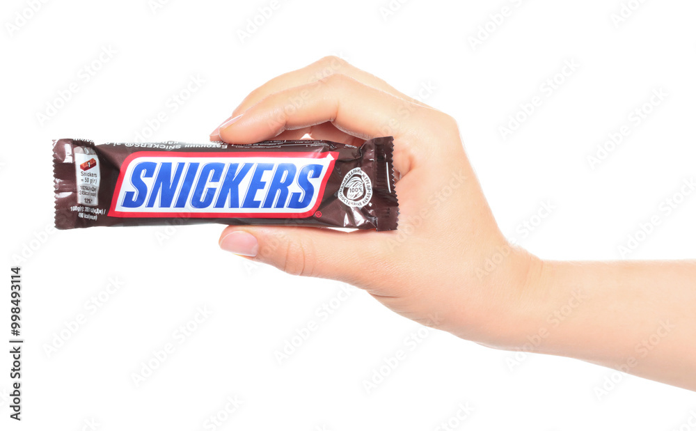 Hand holding Package of the Snickers - Chocolate Bar of Mars ...