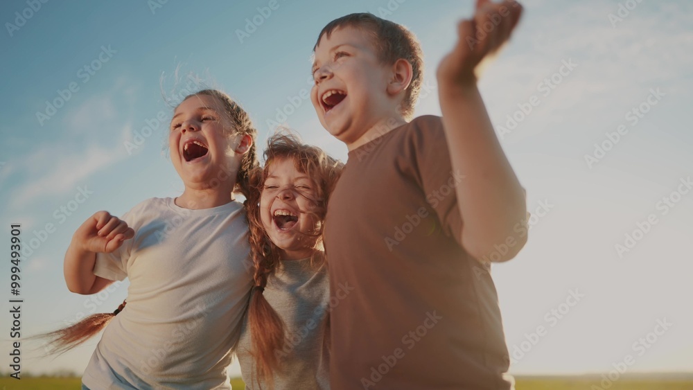 group of kids team hugging a jumping and rejoicing outdoors. happy ...