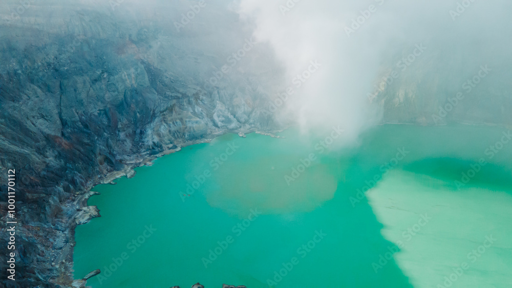 Toxic volcanic gas at the sulphur mines in the crater of the active volcano of Kawah Ijen with ...