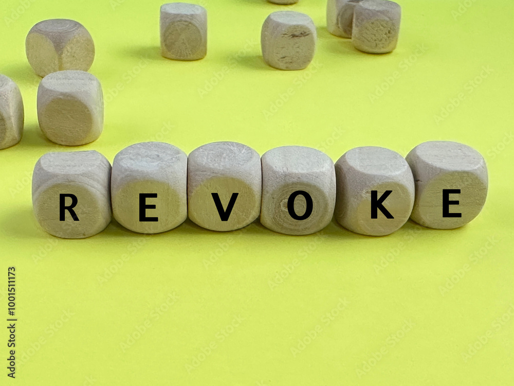letters of the alphabet with REVOKE words written on small wooden cube ...