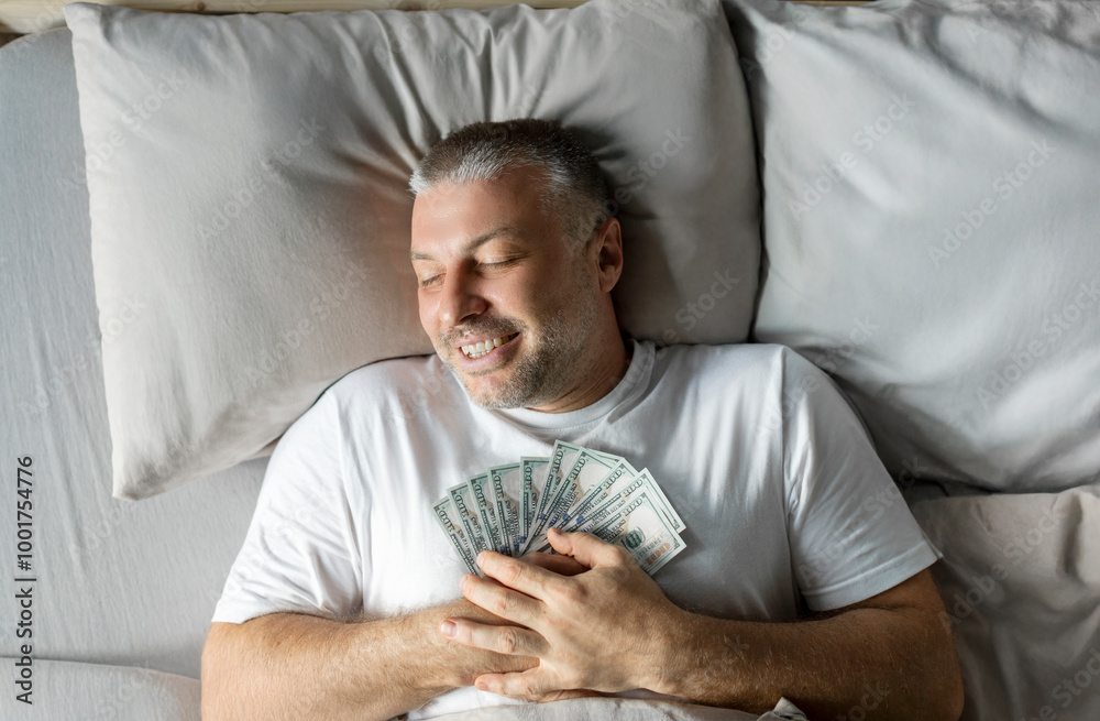 Money savings, financial literacy. Happy middle aged man lying in bed ...