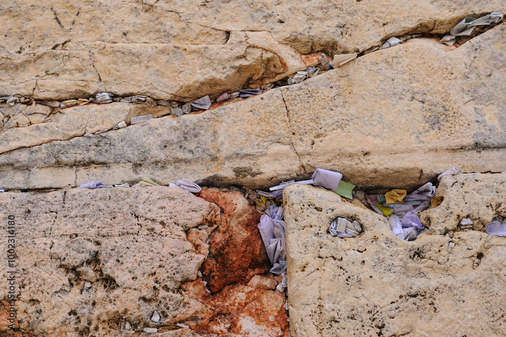 Tiny prayer notes inserted into the cracks and crevices of the Western ...