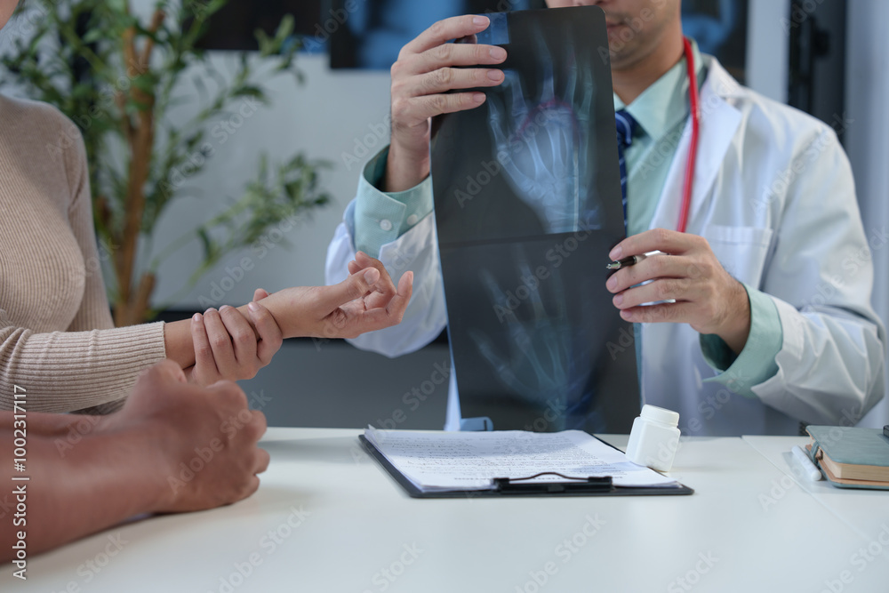 Foto de Stock Asian male doctor explaining bone x-ray examination film ...