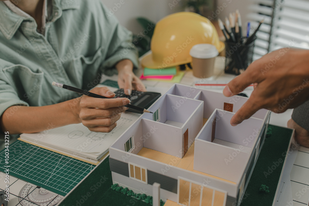 engineer and investor are negotiating the details of a housing project ...