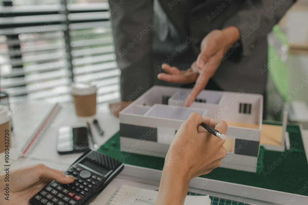 engineer and investor are negotiating the details of a housing project ...