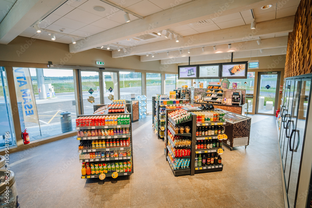 A well-organized convenience store interior with shelves displaying a ...
