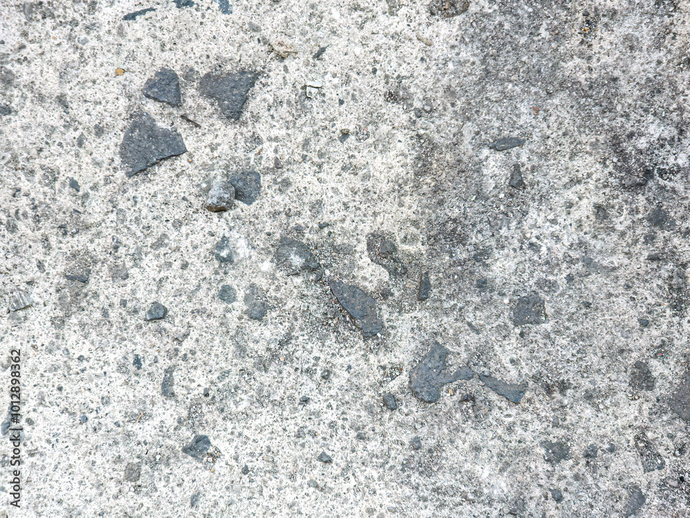 rough concrete texture background with scattered stone. Close-up of a ...