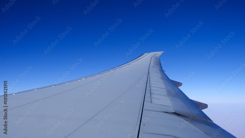 Boeing 777 300ER wing in flight and blue sky Stock Photo | Adobe Stock