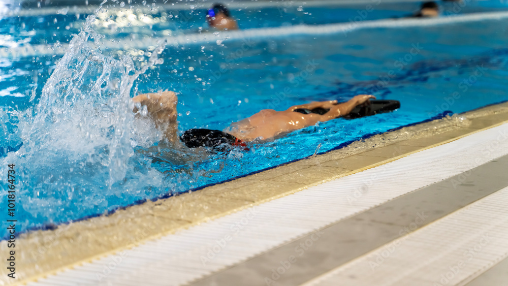 boy learning to swim in the pool with a trainer Stock Photo | Adobe Stock
