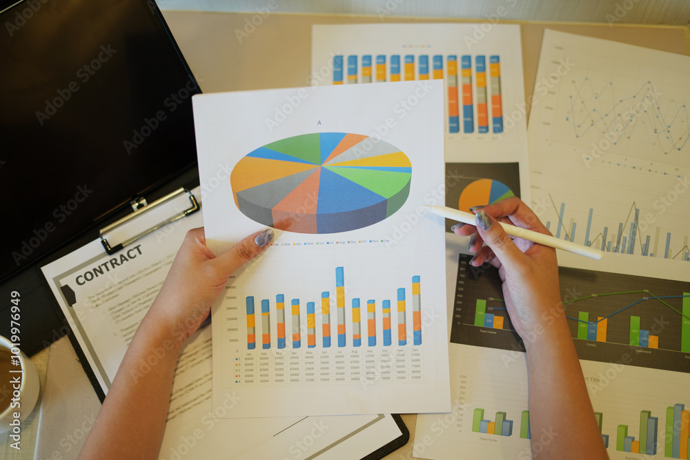 Young Asian woman is re-checking tool work on desk with data analyst ...