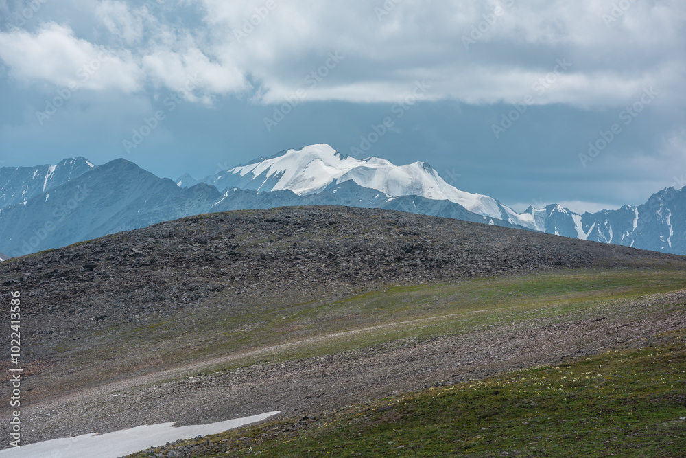 Dramatic layer view to large wide snow-capped mountain range far away ...