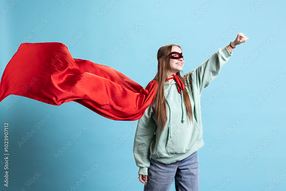 Cheerful girl wearing superhero costume and mask for Halloween with ...