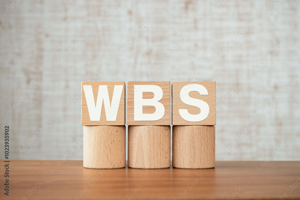 There is wood cube with the word WBS. It is an abbreviation for Work ...