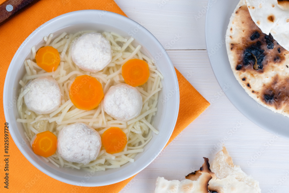 Matzoh ball soup, noodle, vibrant carrots on a white background. Jewish ...