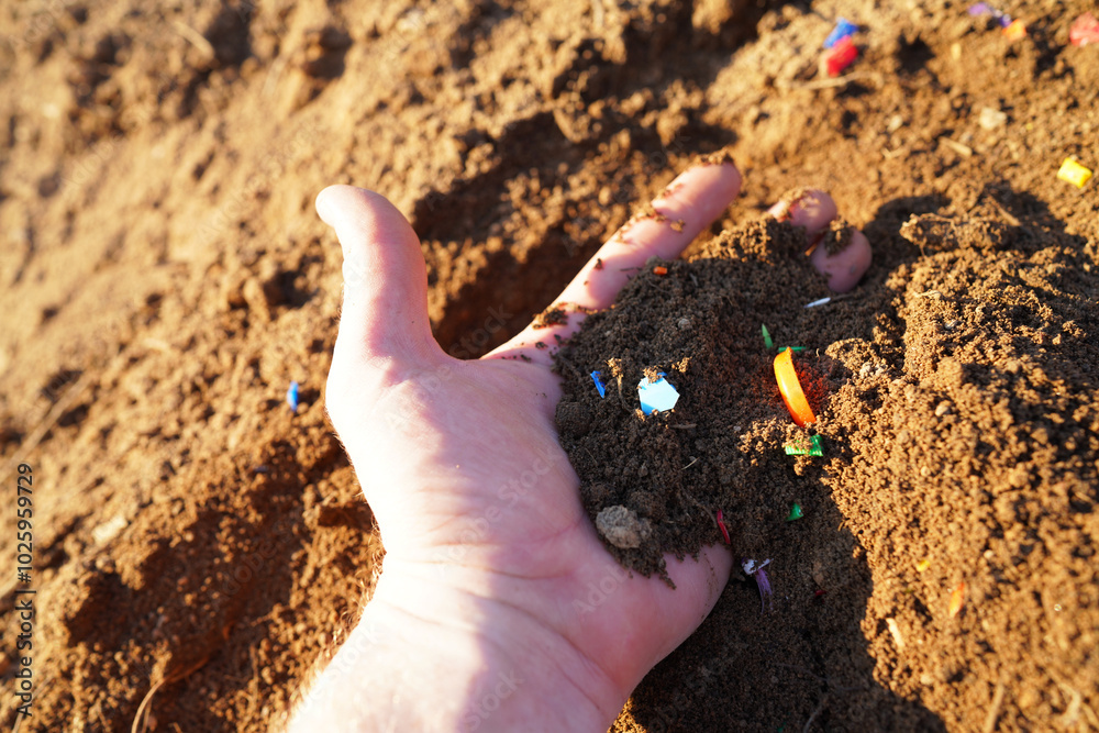 Fotografie Microplastic pollution. Microplastics in ground. Soil ...