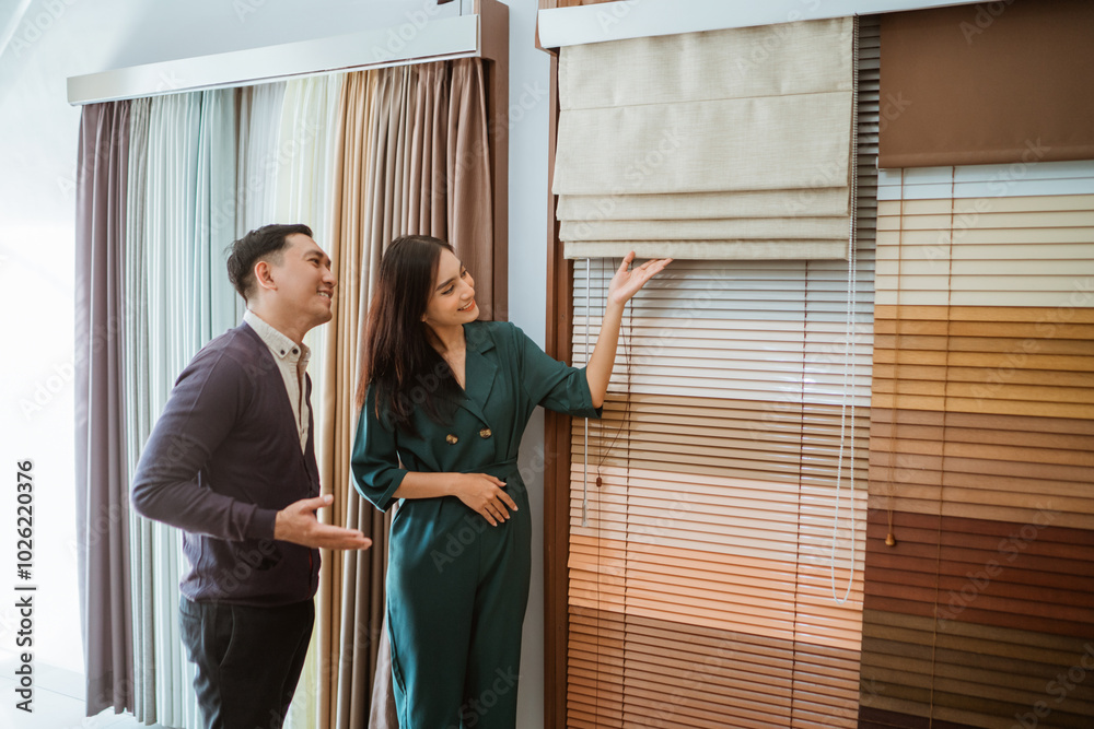 asian female shopkeeper explaining the different types of blinds to the ...