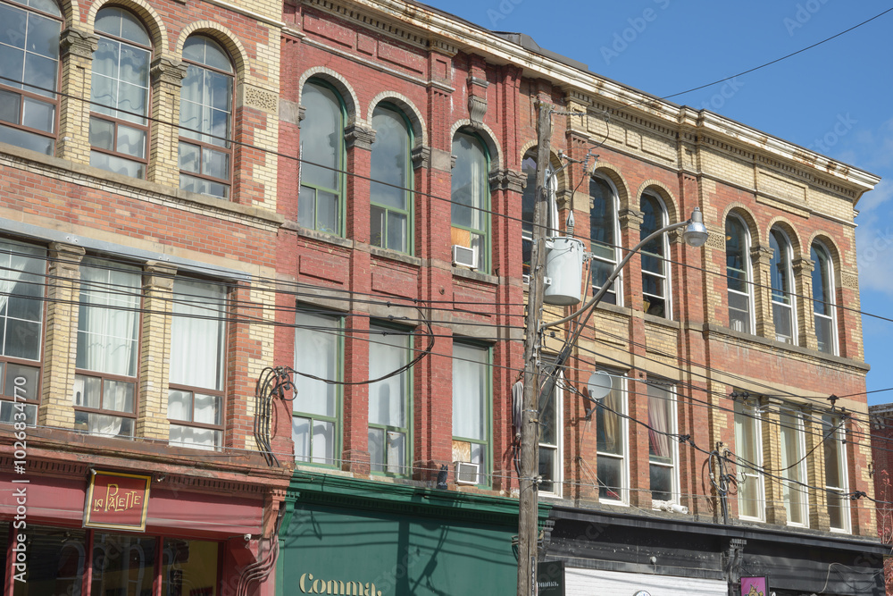 exterior historic building facade with apartment units over shop fronts ...