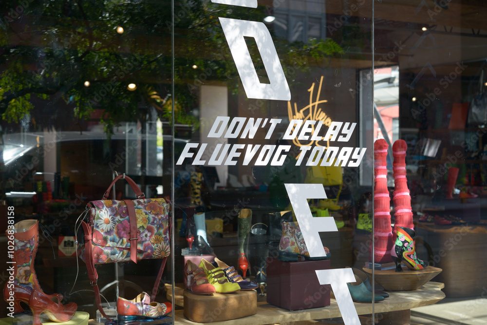 defocused glass window display with vinyl sign and merchandise at John ...