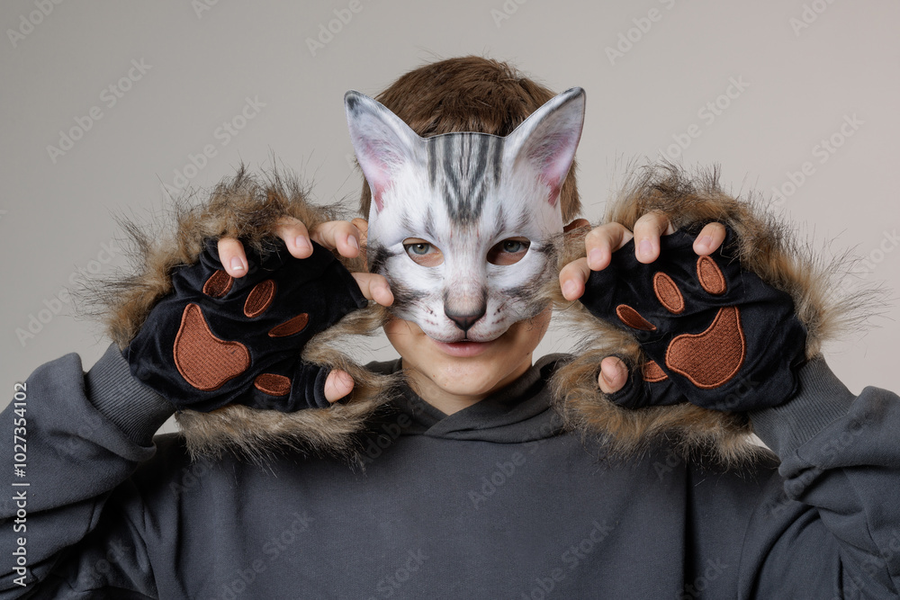 portrait quadrobics Teenager in cat mask on gray background , studio ...