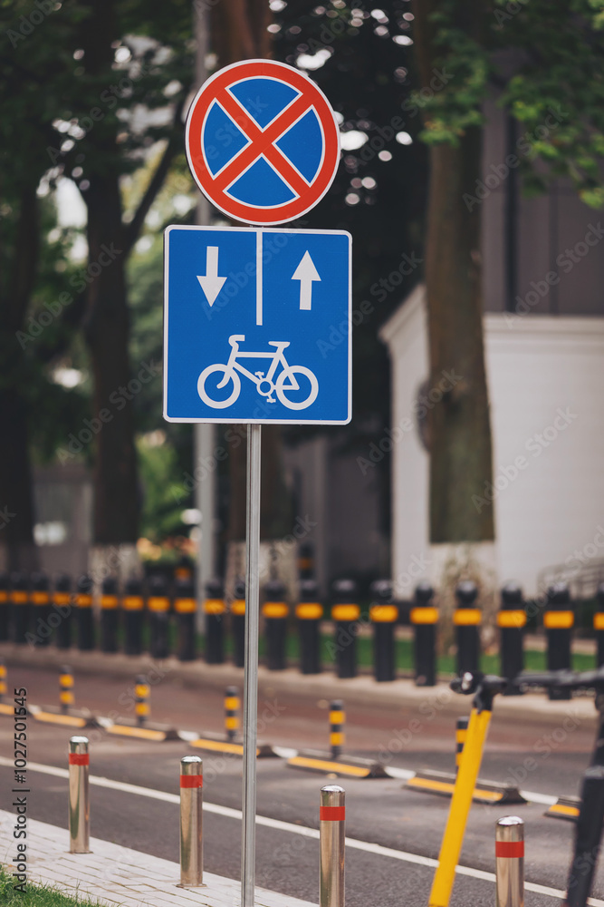 Straight two way cycle lane along side an asphalt road in the middle of ...