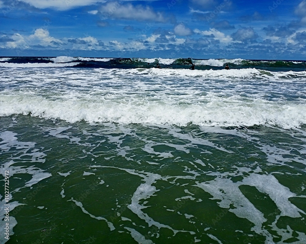 "Crystal-clear ocean waves crash onto the shore, creating a beautiful ...