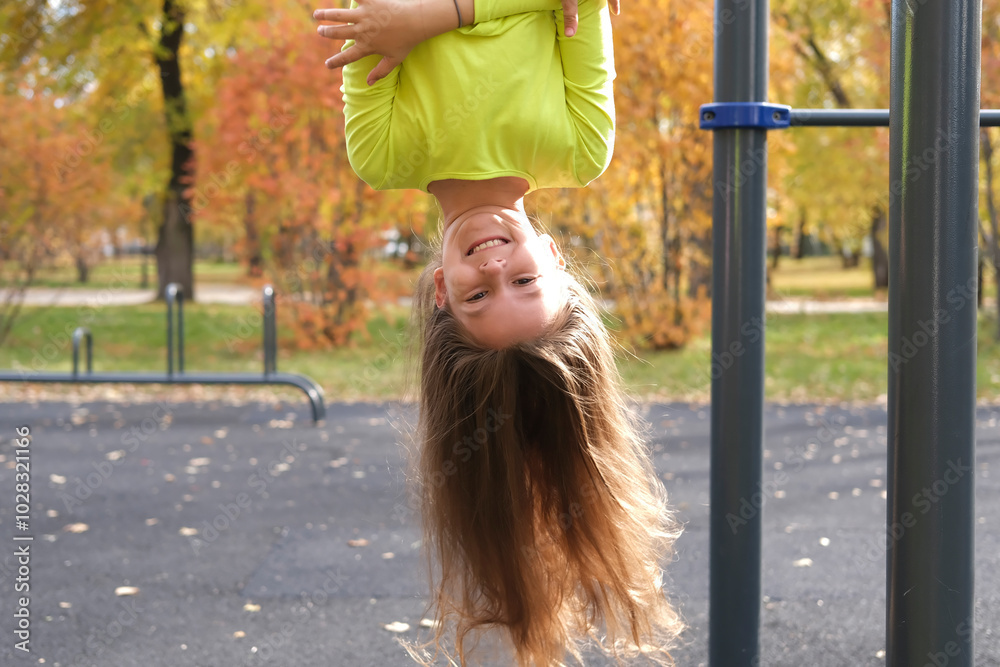 Excited crazy little girl hanging upside down, upside down on ...