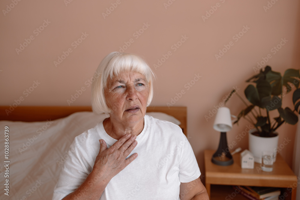 Heart attack. Sick senior adult elderly woman touching the neck feeling ...