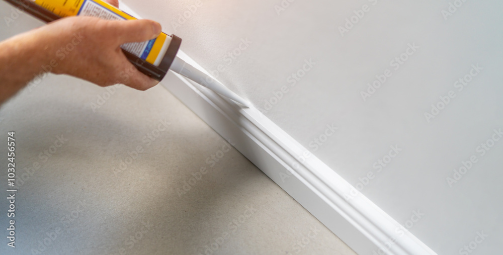 Man installing new skirting board - DIY home work concept Stock Photo ...