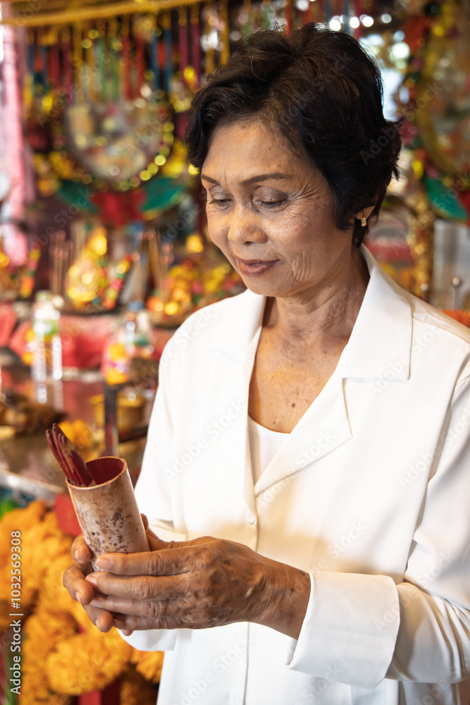Spiritual senior old woman holding yin yang fortune telling wood ...
