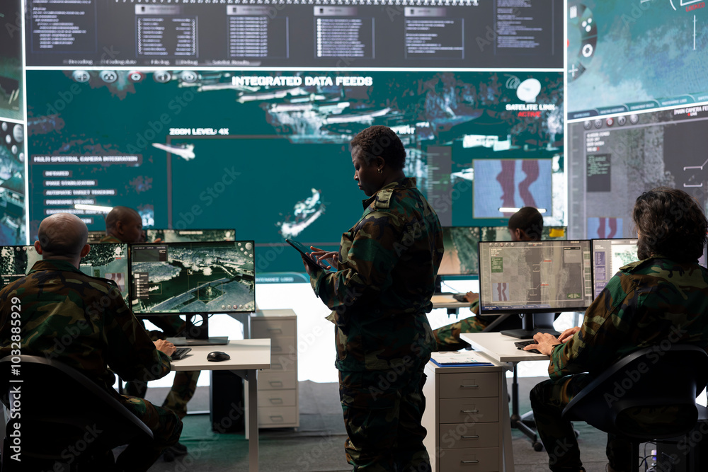 Woman recruit examining important battlefield information from a big ...
