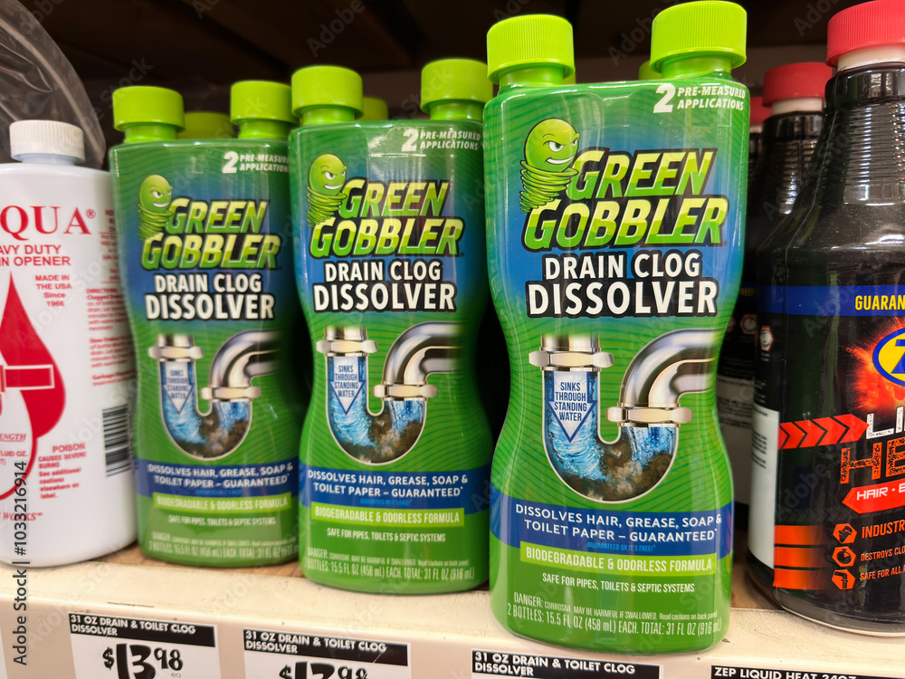 Bottles of Green Gobbler drain clog Dissolver on market shelf. Stock ...