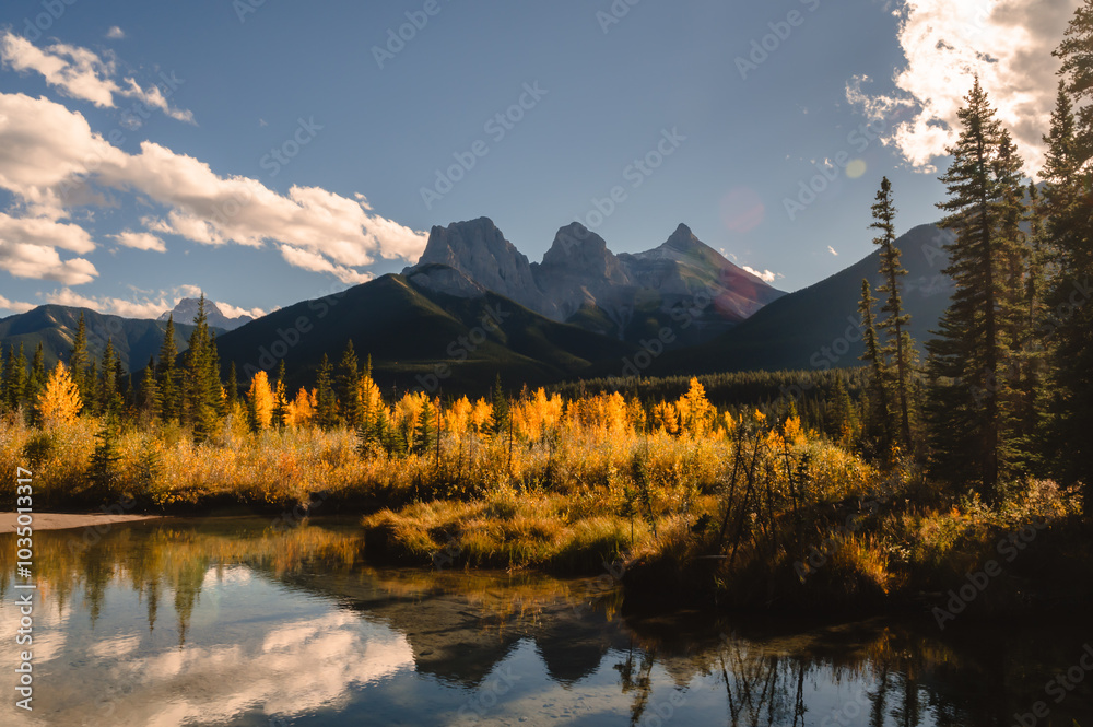 Sun shining on The Three Sisters mountain in Canmore, AB on fall day ...