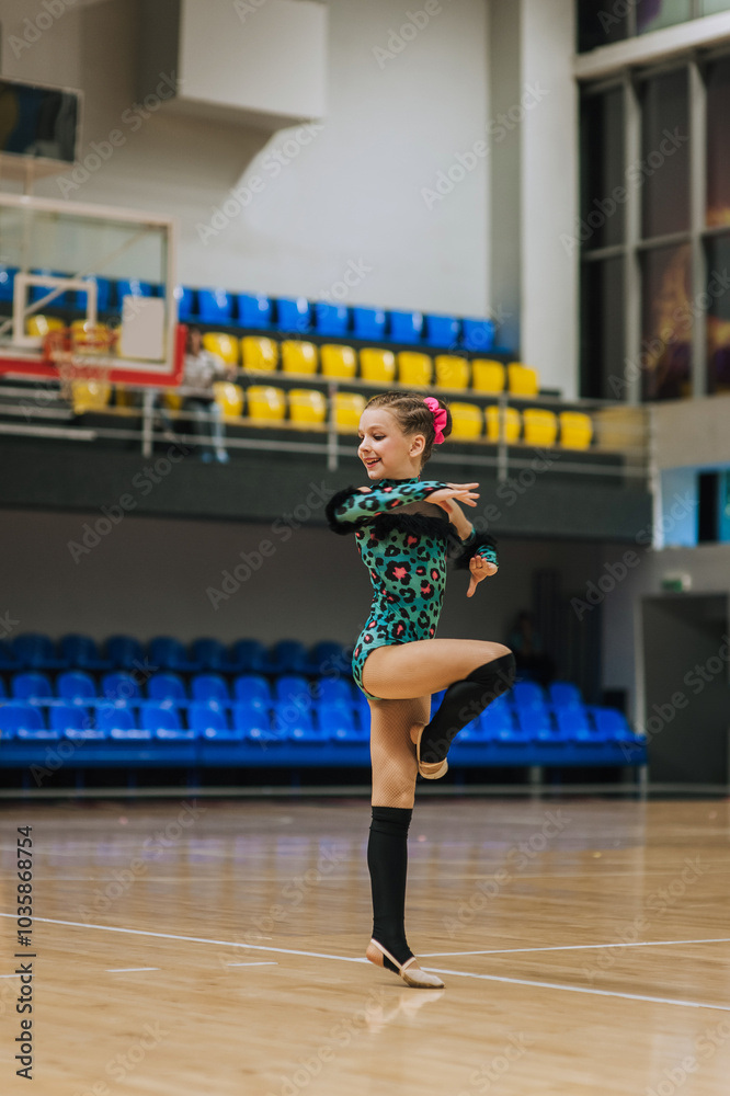 Beautiful girl athlete, smiling child professional gymnast in blue suit ...