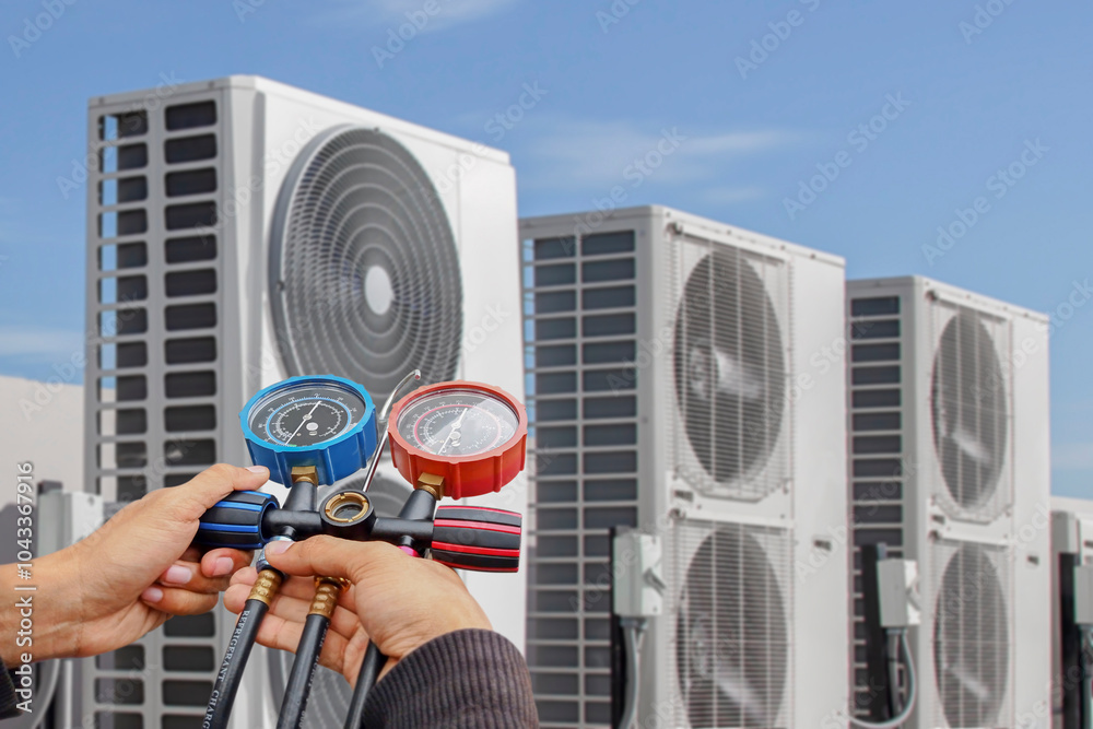 Air conditioning, HVAC service technician using gauges to check ...