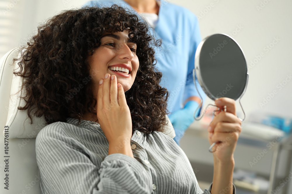 Patient looking in mirror and doctor in clinic, selective focus. Dental ...