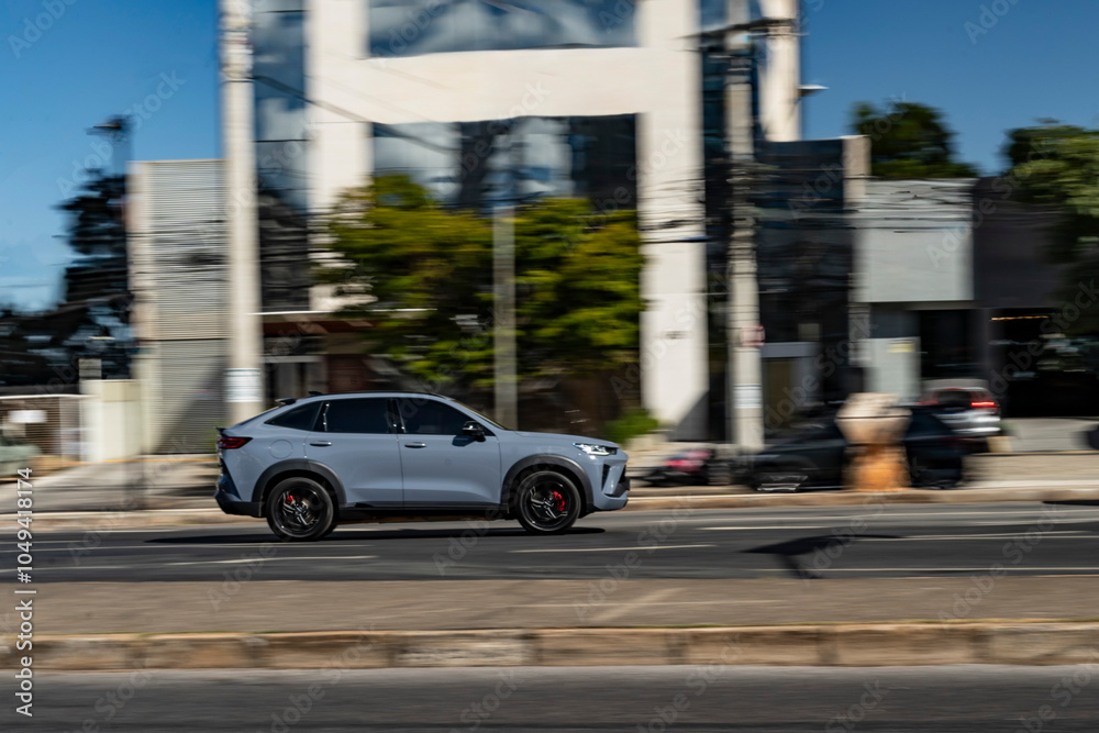 Grey GMW Haval H6 GT cruising city, Hybrid SUV panning Shot Stock Photo ...