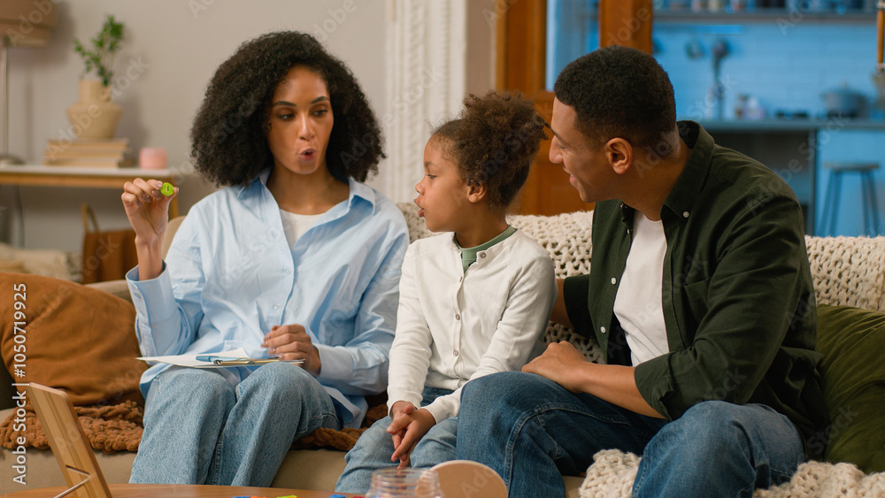 Стоковое фото «African American mother speech therapist hold letter ...