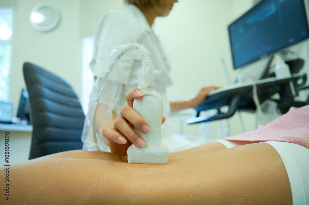 Pediatric ultrasound scan. Child ultrasound. Pediatrician scanning leg ...