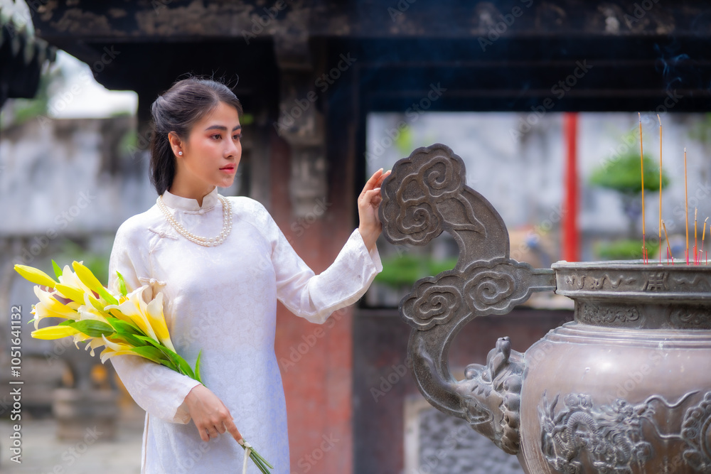 Vietnamese girl with Ao Dai dress standing in temple in Ho Chi Minh ...