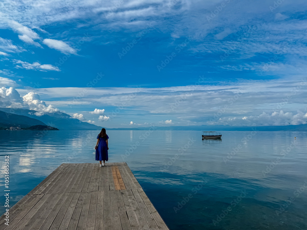 Tourist woman modeling on wooden platform with panoramic morning views ...
