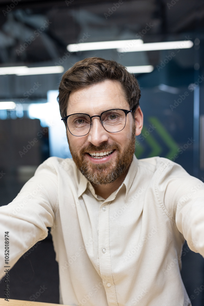 Vertical close-up photo of a young man in glasses and a shirt who is in ...