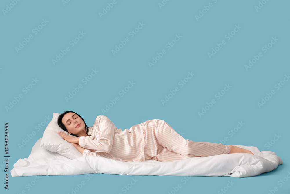 Pretty young woman sleeping in bed on blue background Stock Photo ...