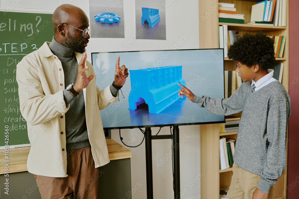 Educator explaining 3D modeling process to student using digital ...