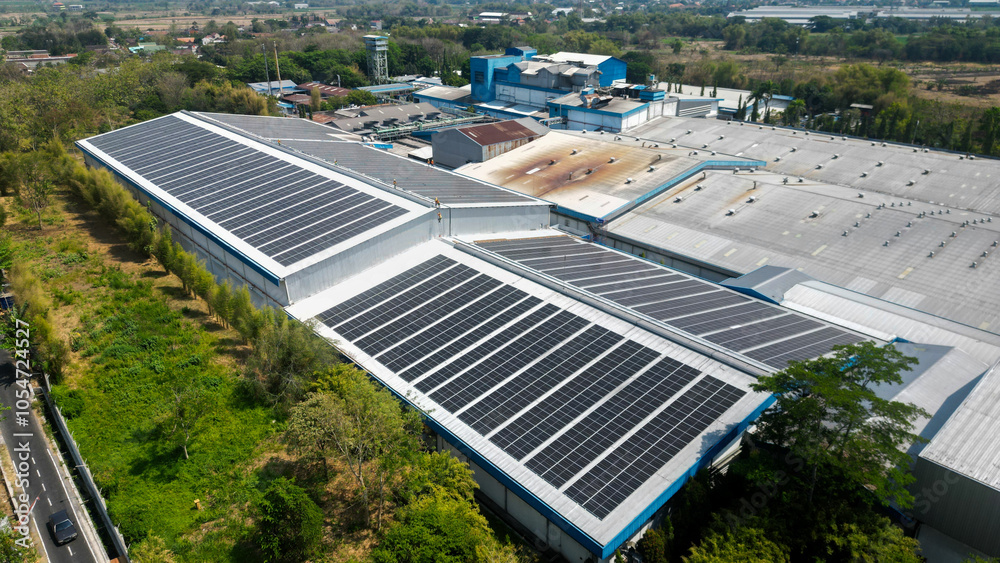 A large factory with solar panels installed across its expansive ...