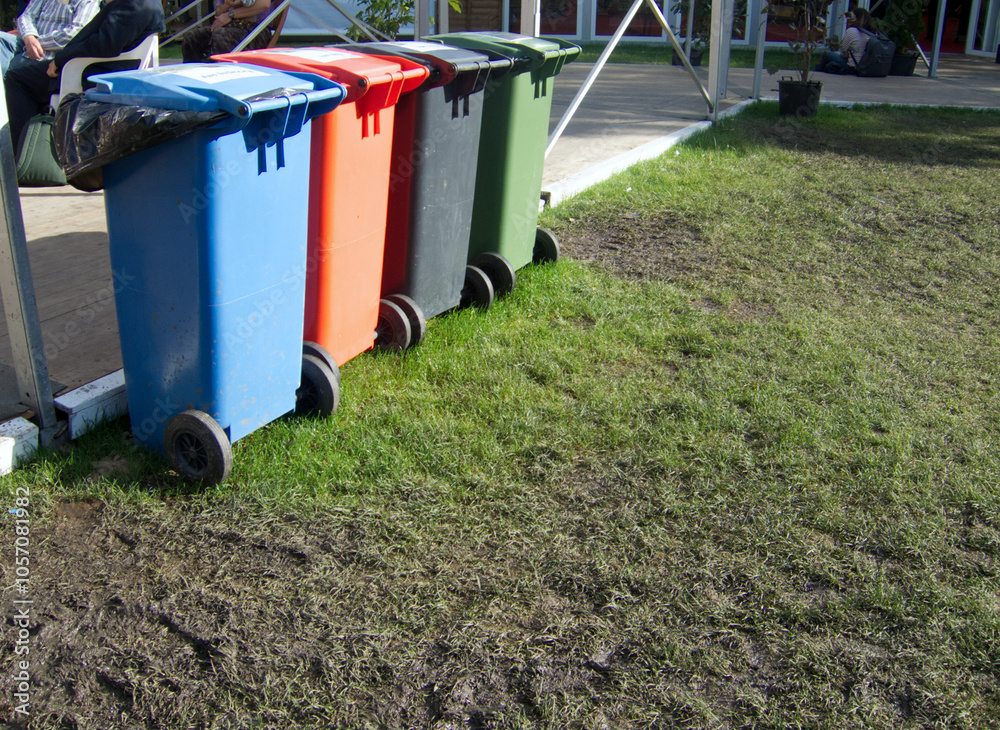 Multiple different types colors of refuse bins in a row, labelled for ...