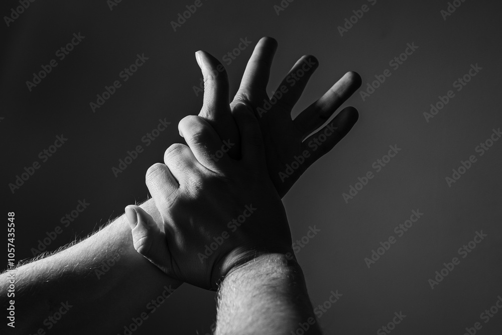 Two human hands making delicate and expressive gestures against a plain ...